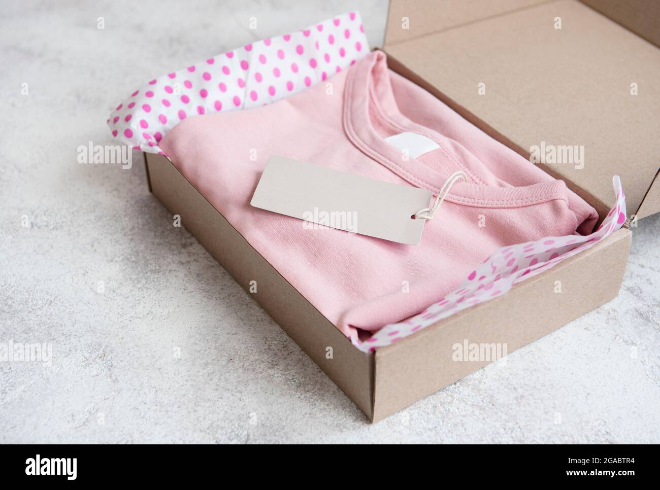 Clothes for kids in an open cardboard box. Online shopping concept ...