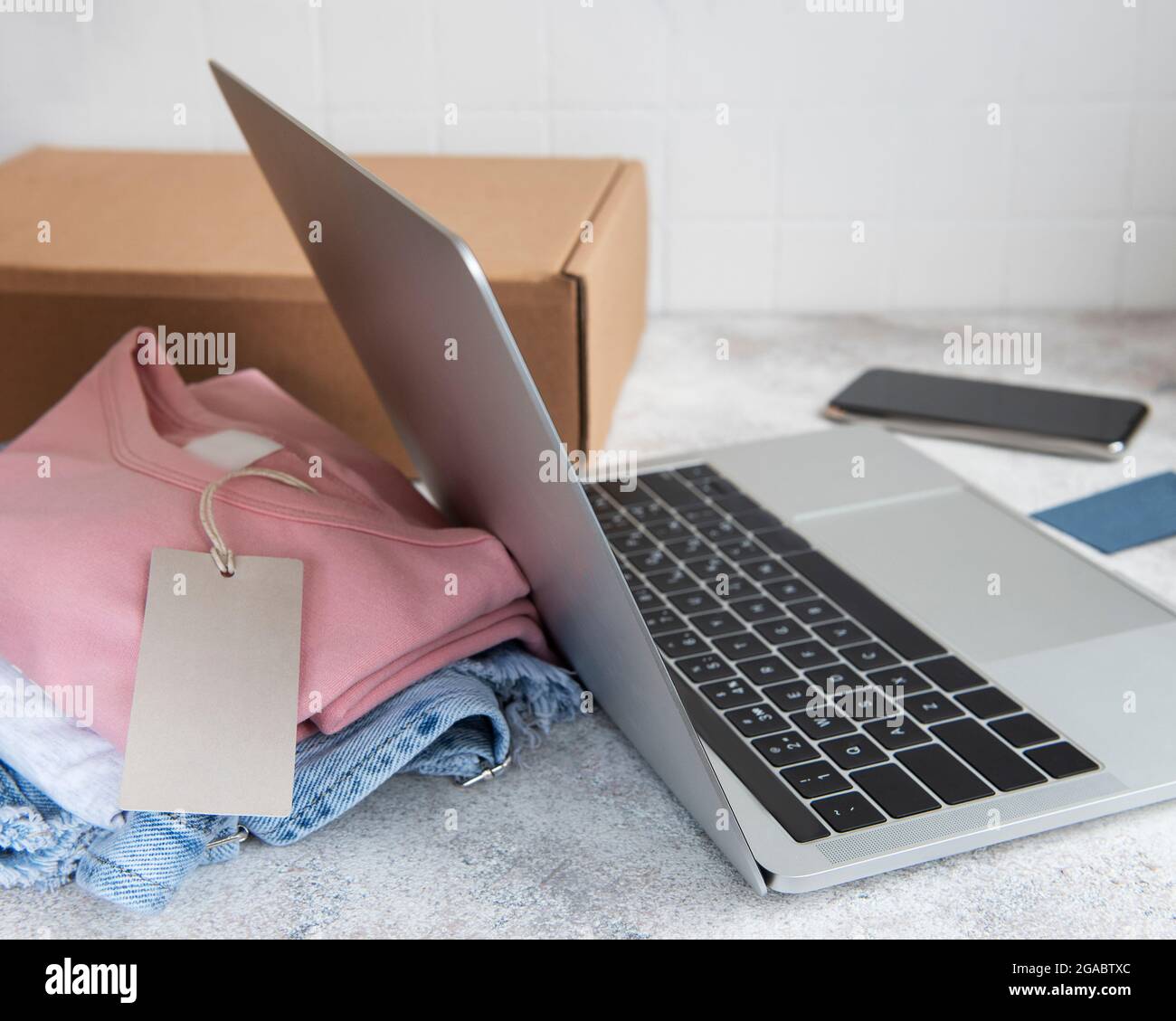 Online shopping concept. A laptop and a set of women's clothing in a ...