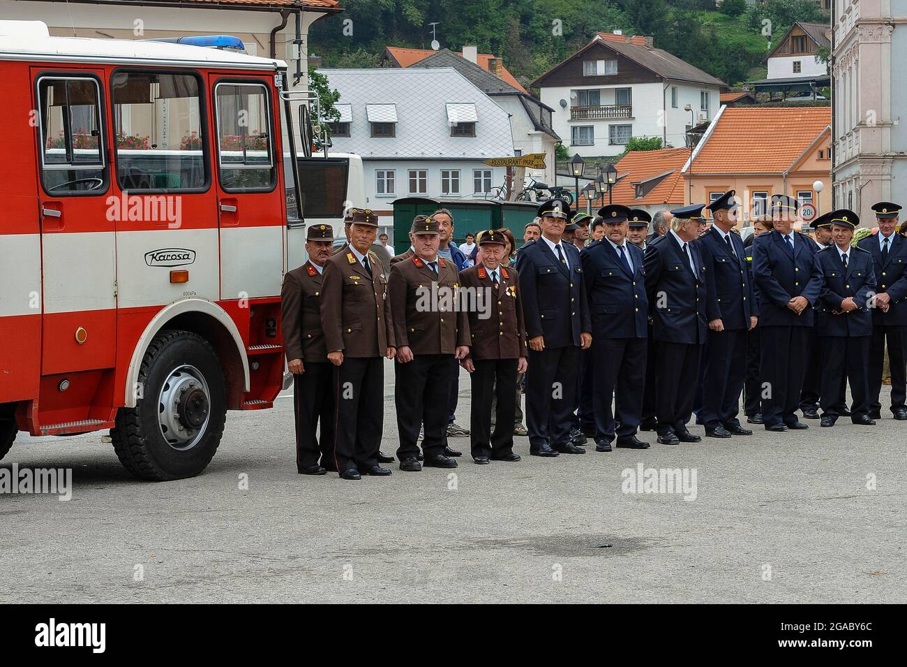 Czech volunteer firefighters (blue uniforms) stand together with their ...