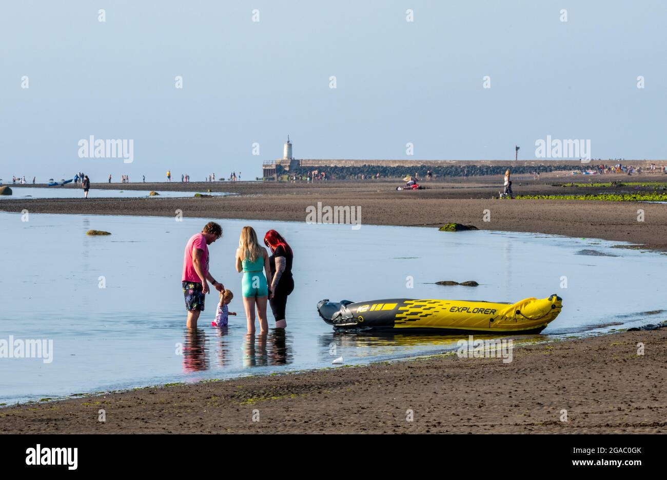 family at the seaside, family on the beach with inflatable, hot summers ...