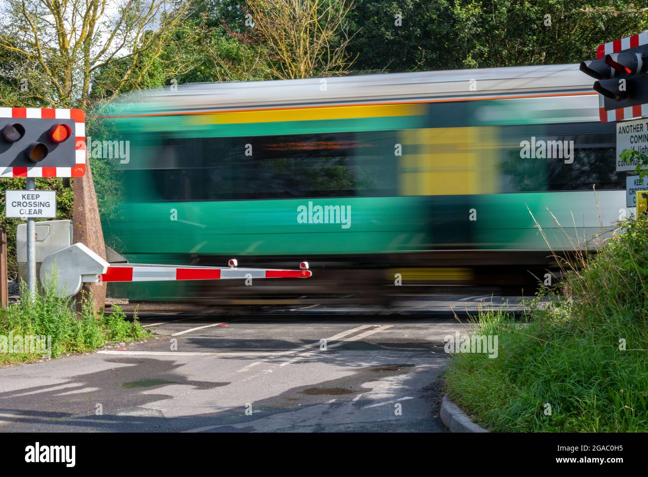 railway level crossing, fast train passing level crossing, southern ... railway level crossing, fast train passing level crossing, southern ...
