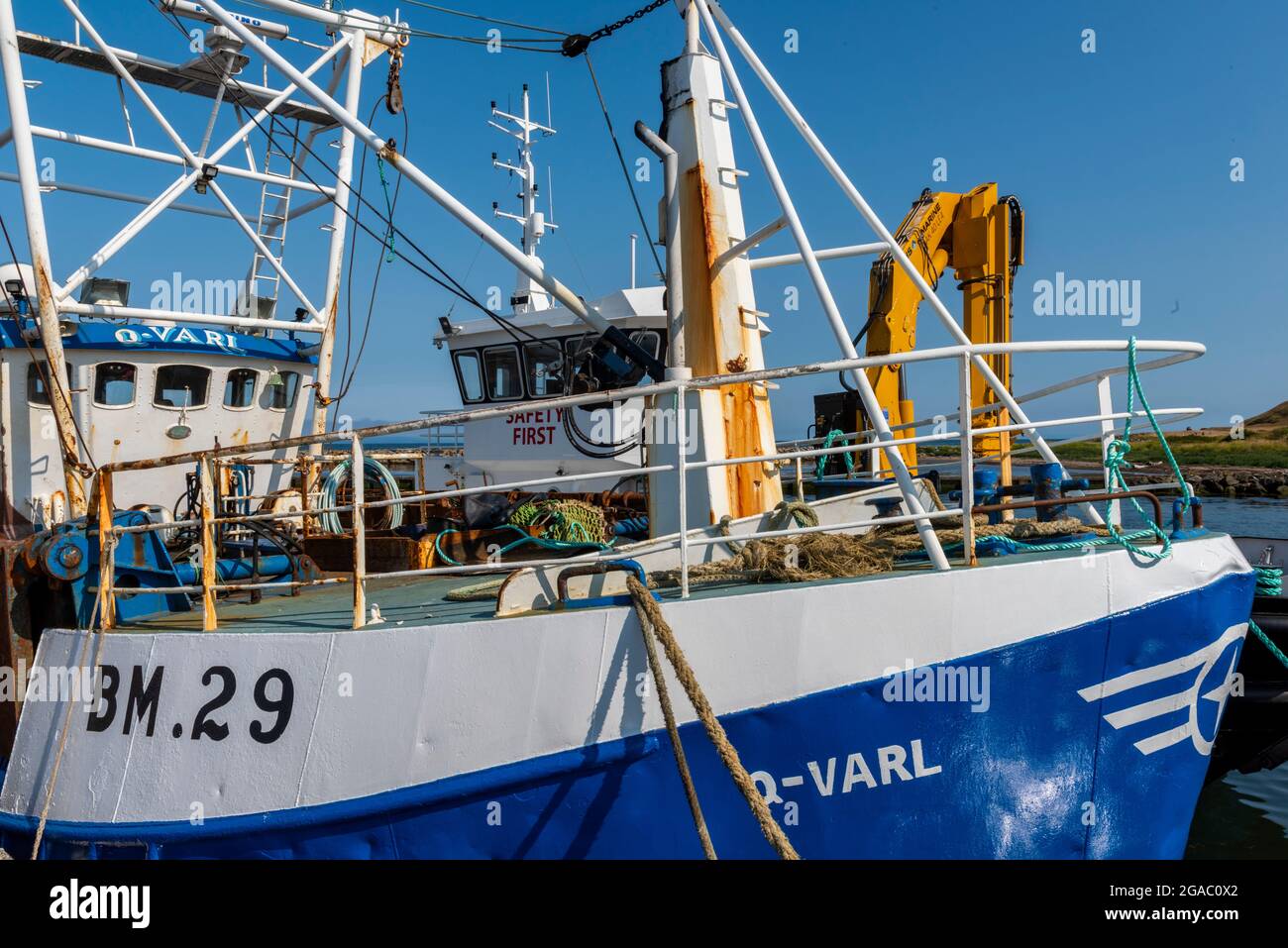 Fishing trawlers and boats alongside the wall berthed in Girvan harbour ...