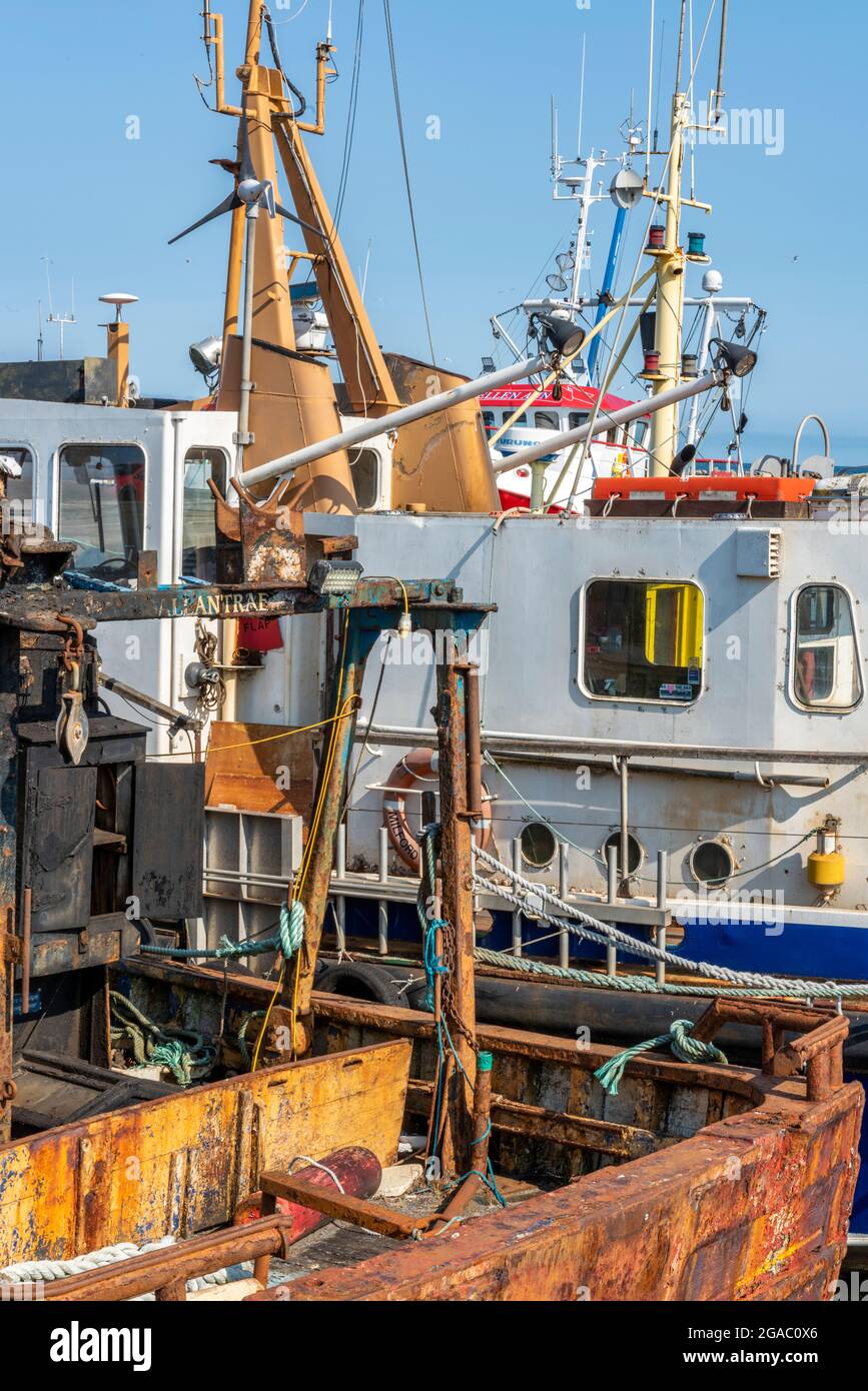 Fishing trawlers and boats alongside the wall berthed in Girvan harbour ...