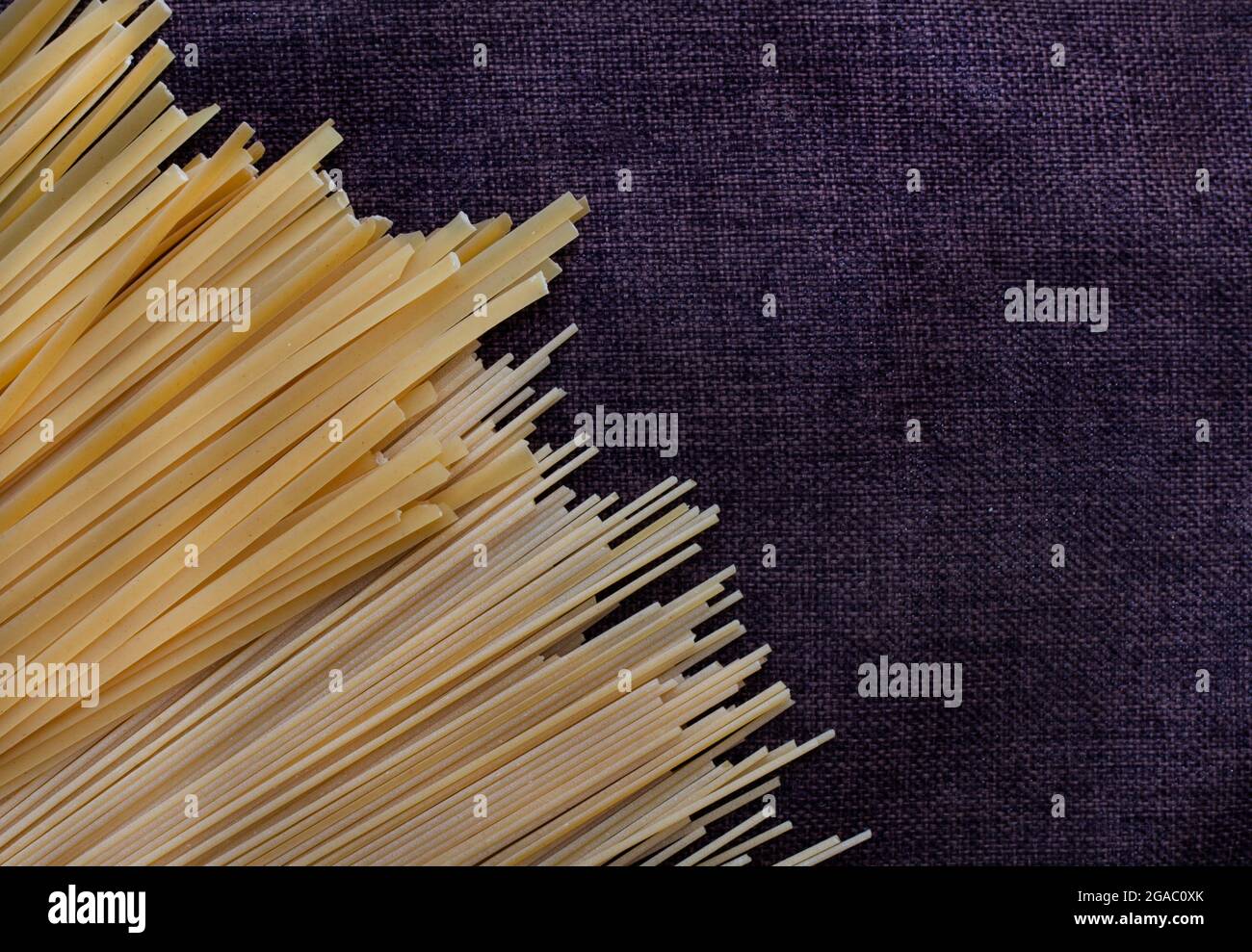 raw pasta in corner with rough textures cloths and ample copy space ...