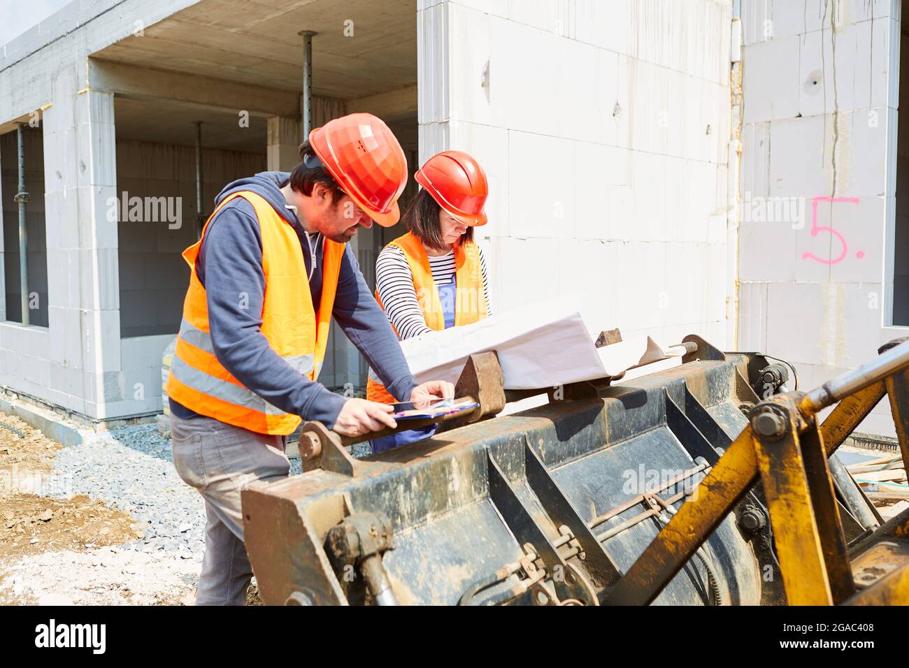 Architect and worker as foreman plan construction work together on the ...