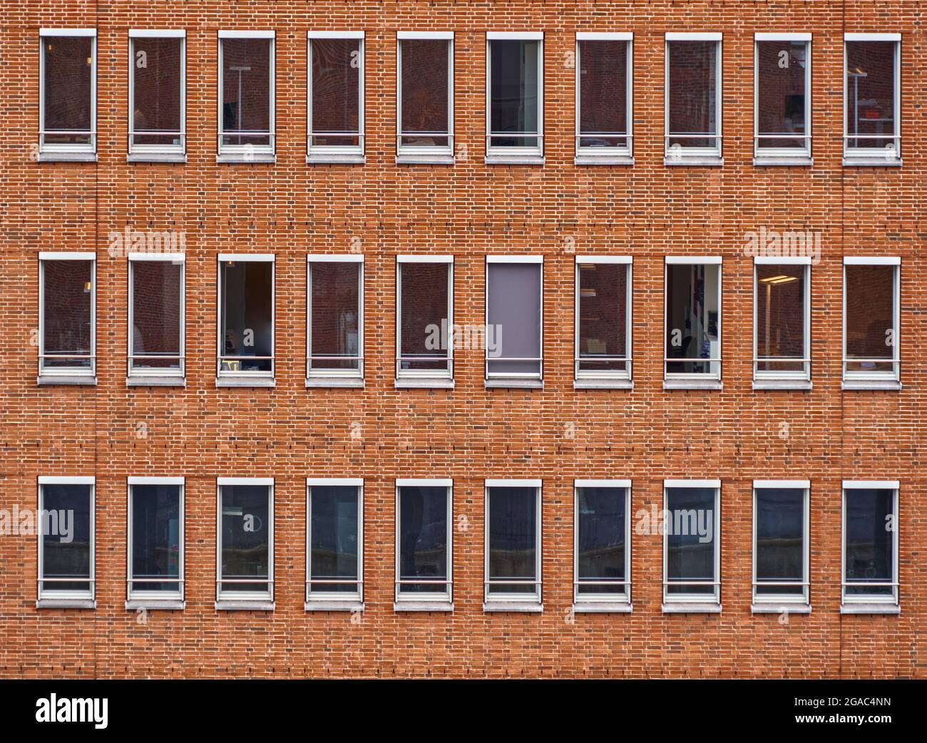 Monotonous facade of red bricks of a high-rise office building with ...