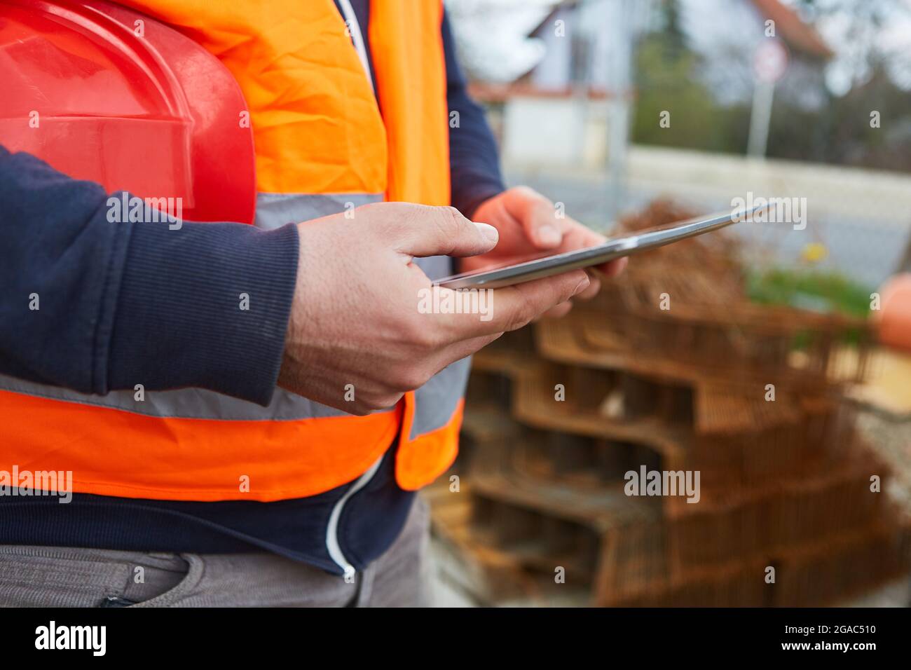 Construction worker or handyman using tablet computer online during ...