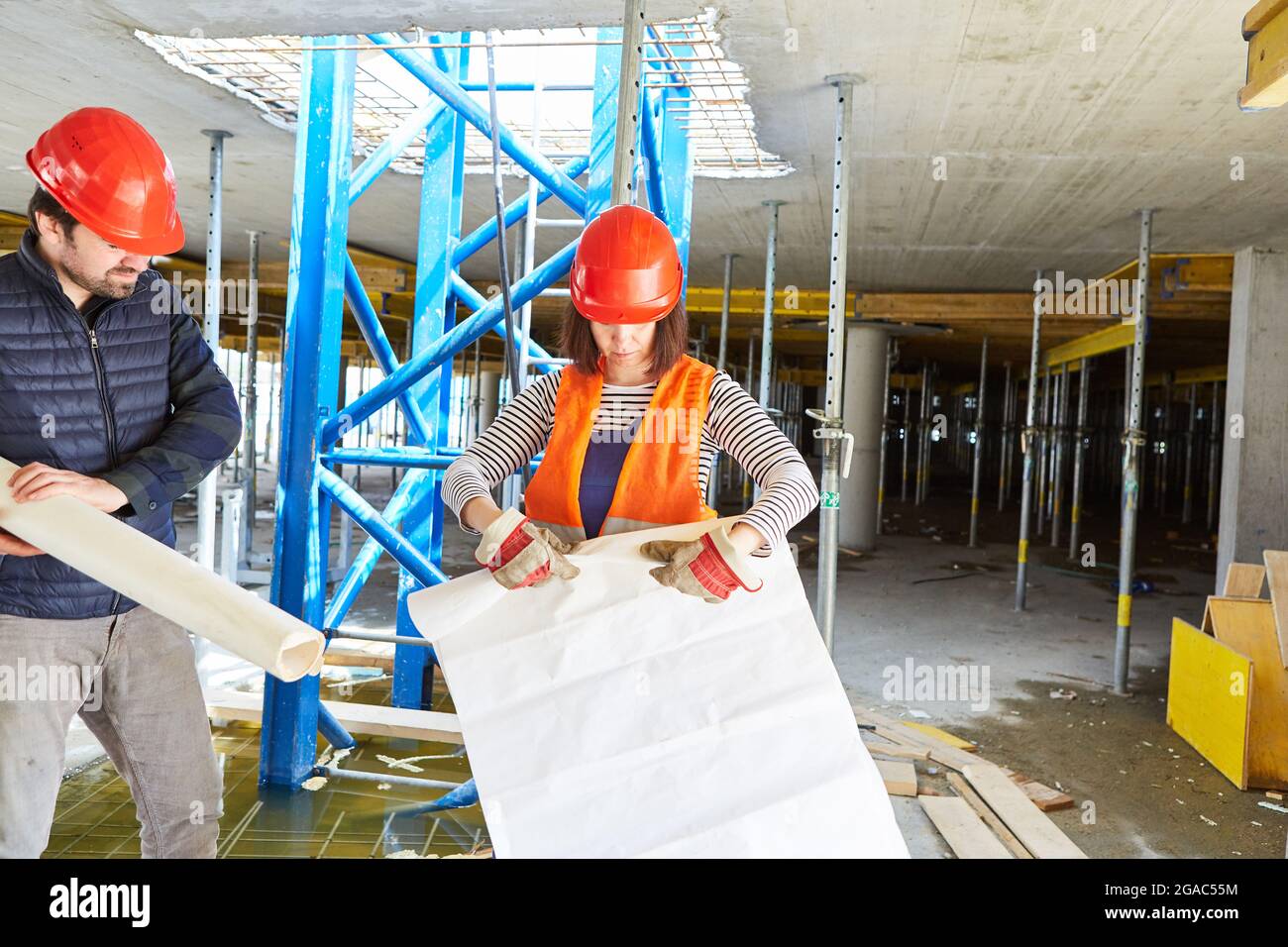 Architect and craftsman with floor plan for planning the construction ...
