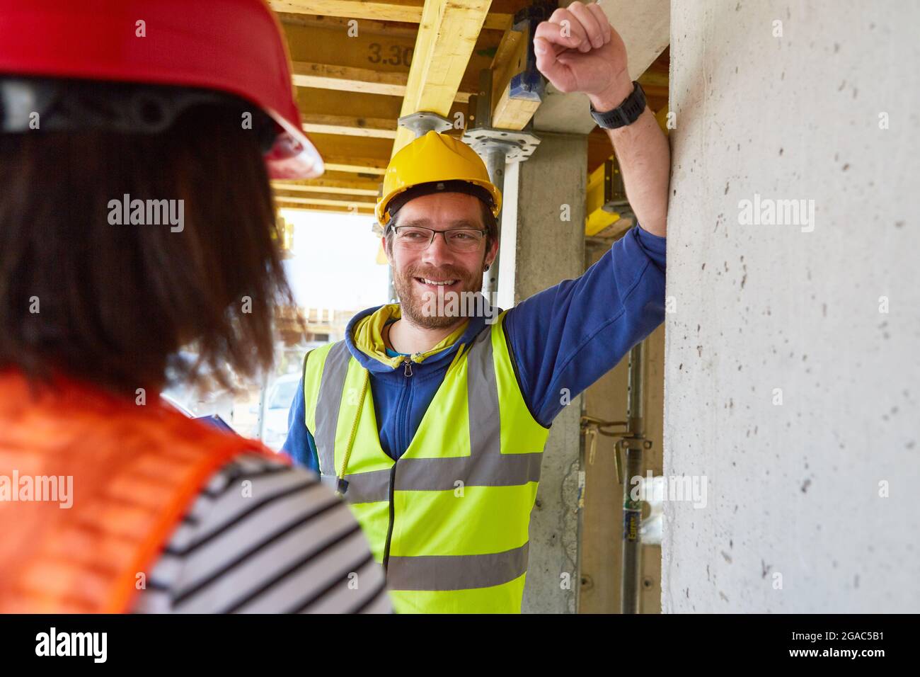 Smiling construction worker as a foreman in conversation with the ...