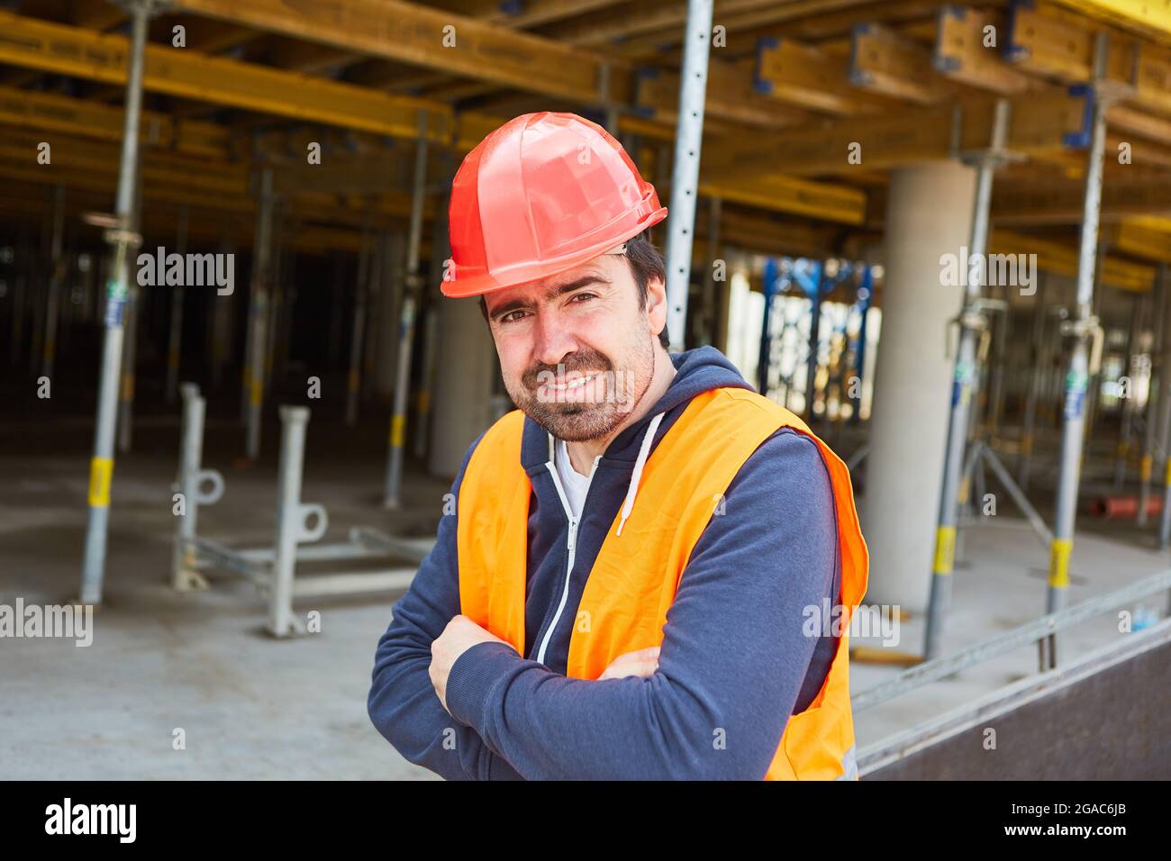 Craftsman or construction worker with folded arms on the shell of a ...