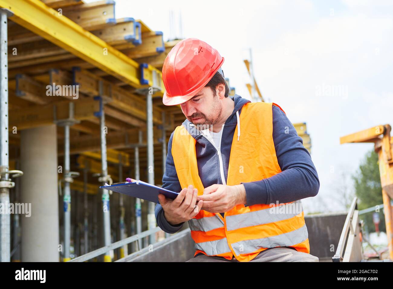Foreman or architect with test report or checklist on the construction ...