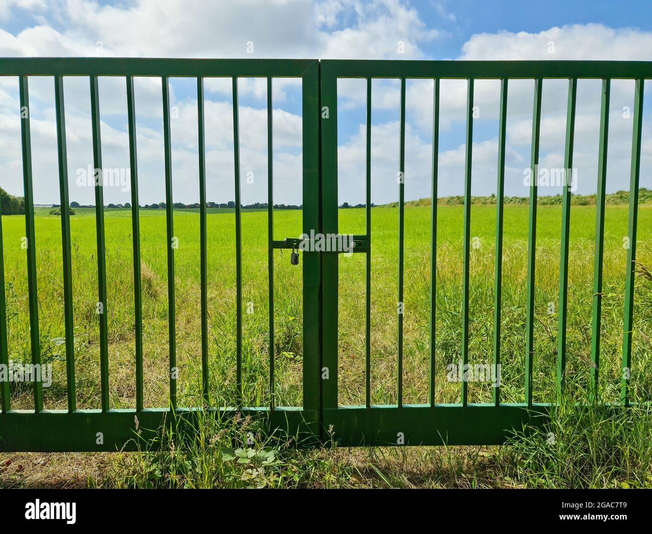 Big green metal gate to a field Stock Photo - Alamy