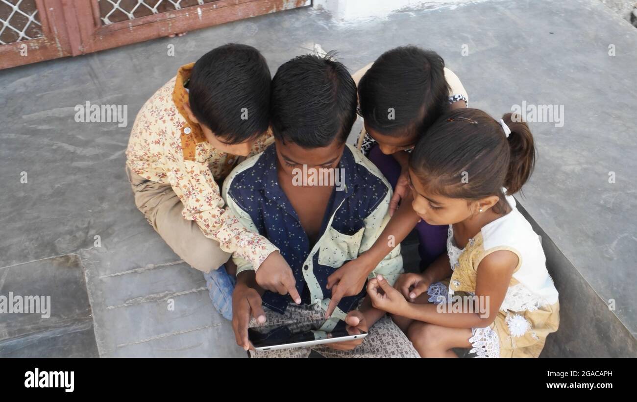 Rural children using a tablet, India. Top view Stock Photo - Alamy