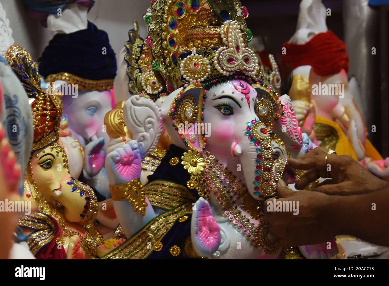 Kolkata, India. 29th July, 2021. An artisan works on an idol of Hindu ...