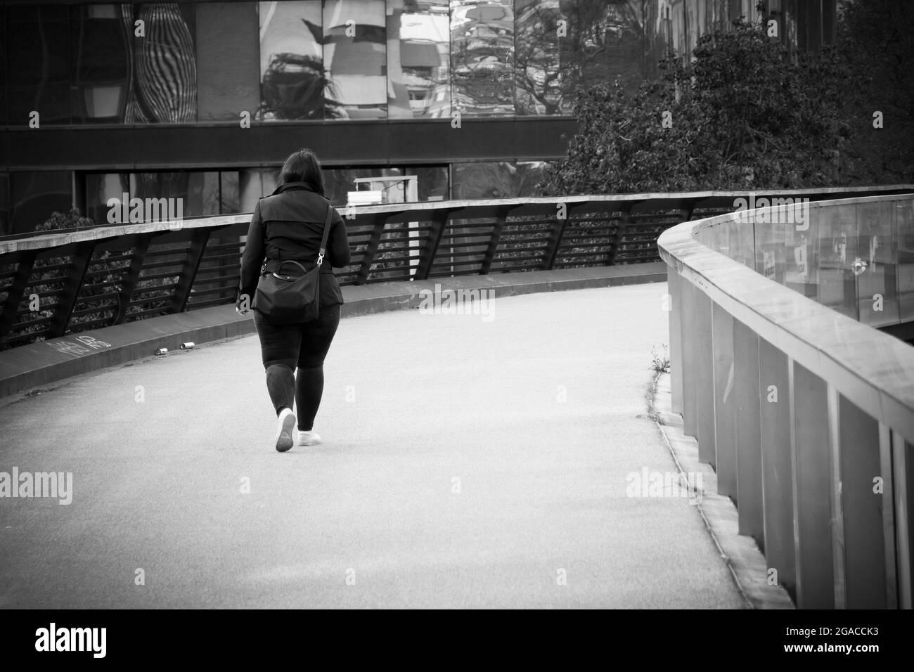 Woman walk bridge back view Black and White Stock Photos & Images - Alamy