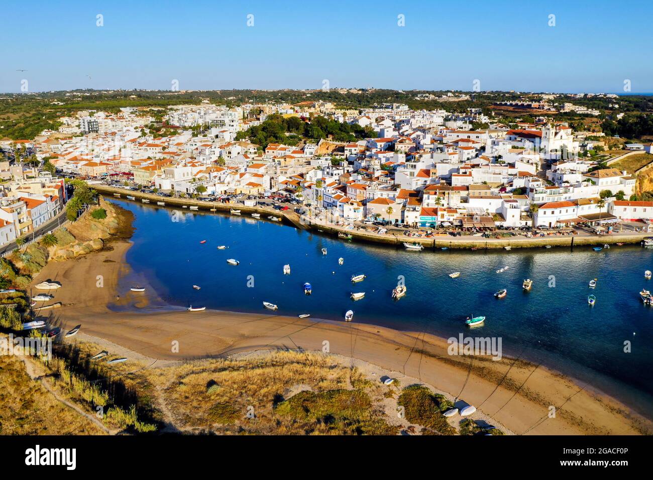 Aerial cityscape of white washed Ferragudo by Arade River, Algarve ...
