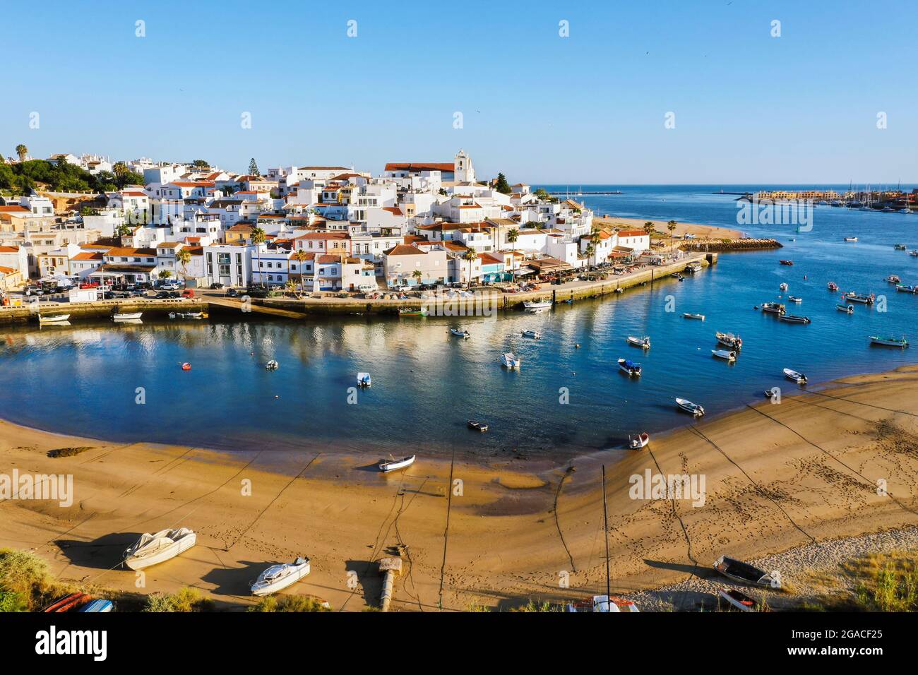 Aerial cityscape of white washed Ferragudo by Arade River, Algarve ...