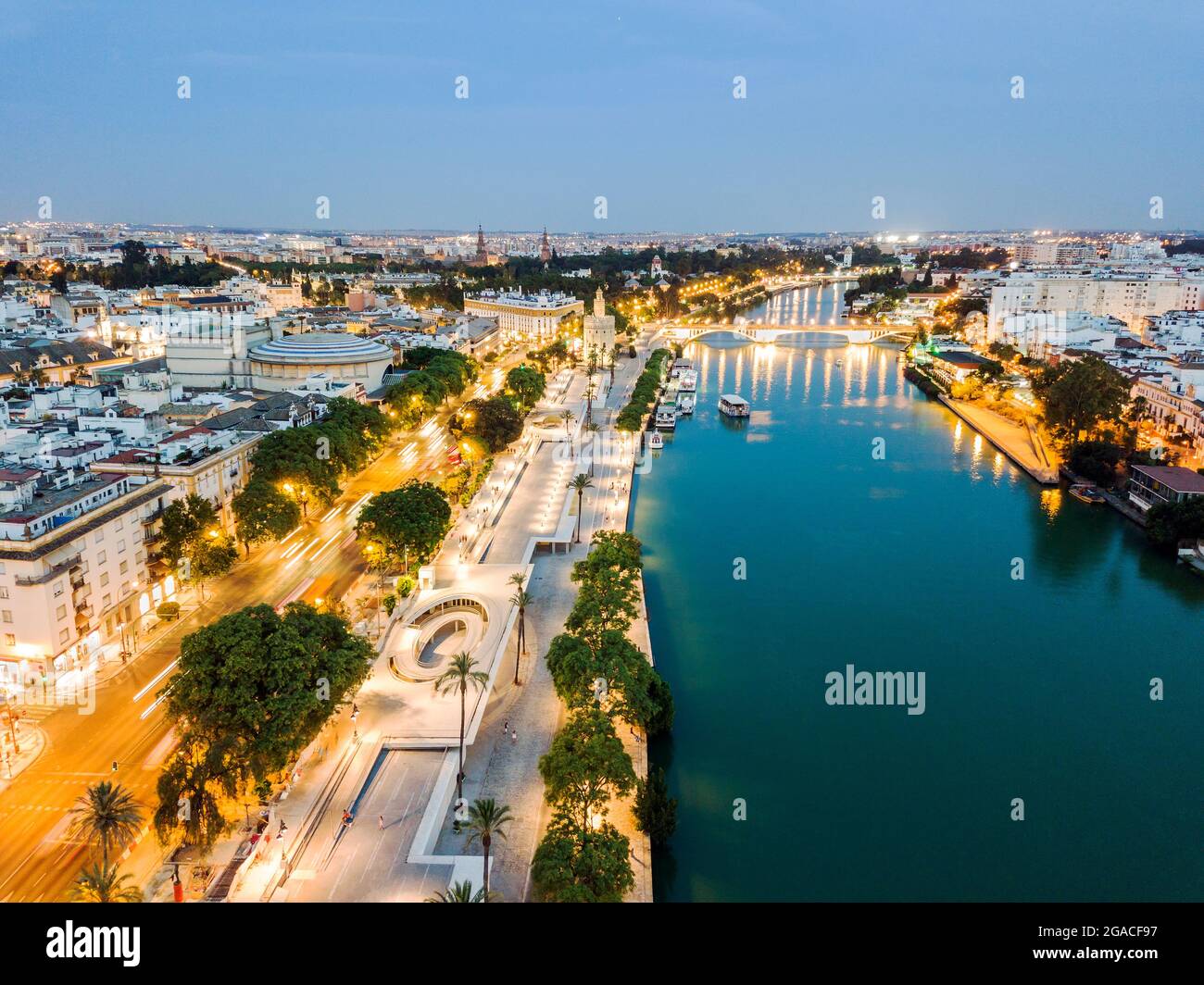 Aerial view of historic part with the river in Seville by the evening ...