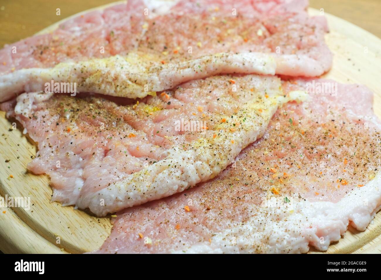 Pork meat spiced with seasoning. Pork chop on kitchen cutting board ...