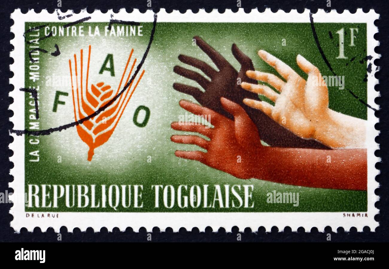 TOGO - CIRCA 1963: a stamp printed in Togo shows Hands Reaching for FAO ...