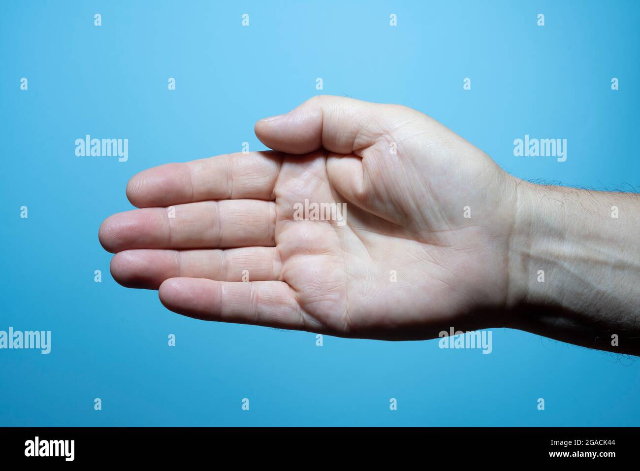 The palm of a man's hand with the blue background Stock Photo - Alamy