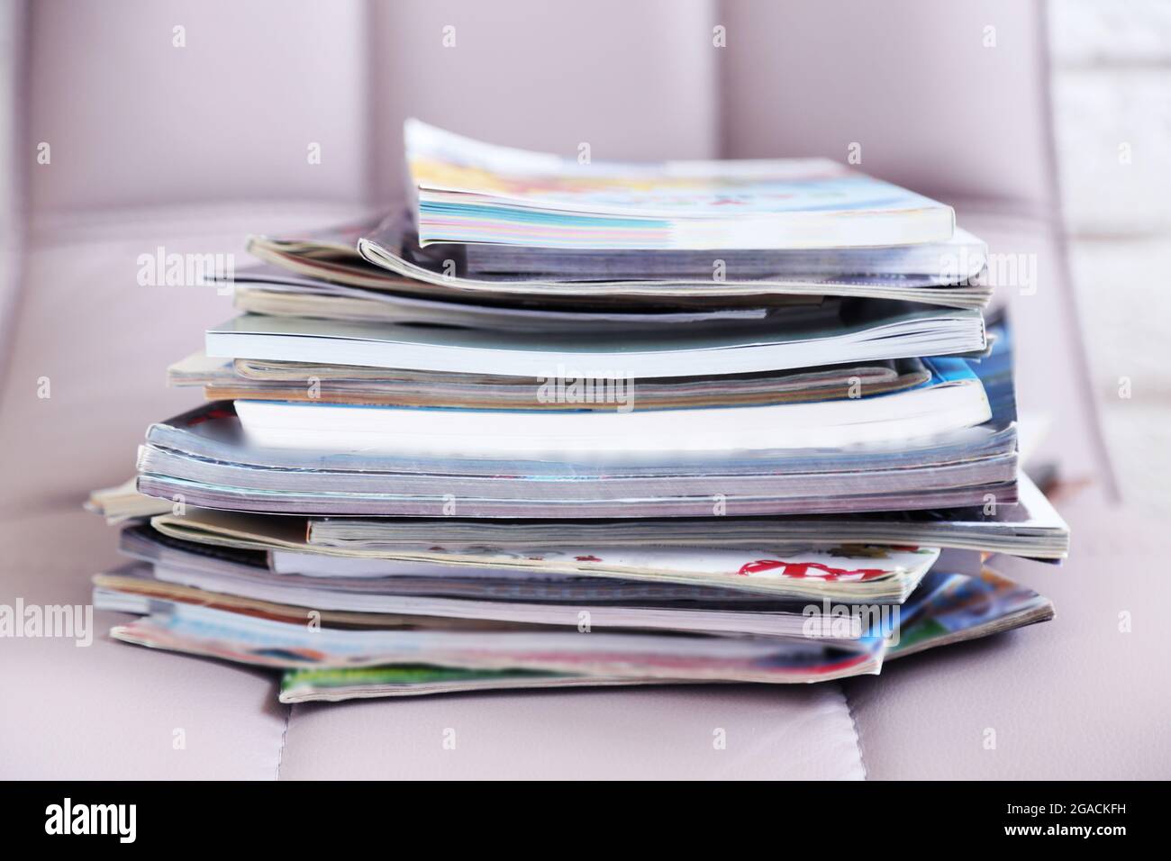 Stack of magazines on chair, close up Stock Photo - Alamy