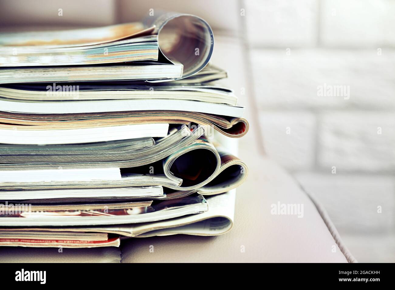 Stack of magazines on chair, close up Stock Photo - Alamy