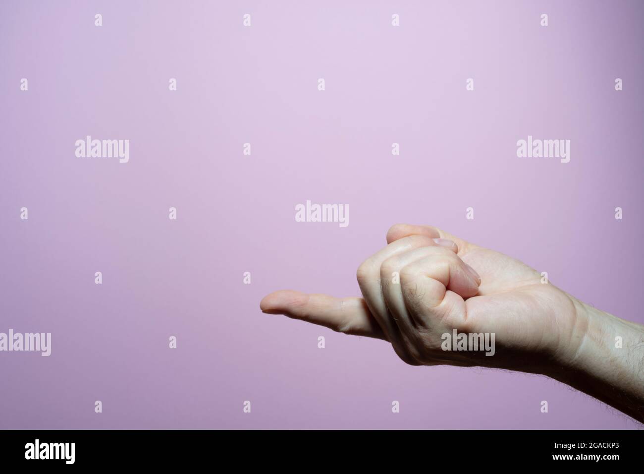 the finger of a man's hand with a pink background Stock Photo - Alamy