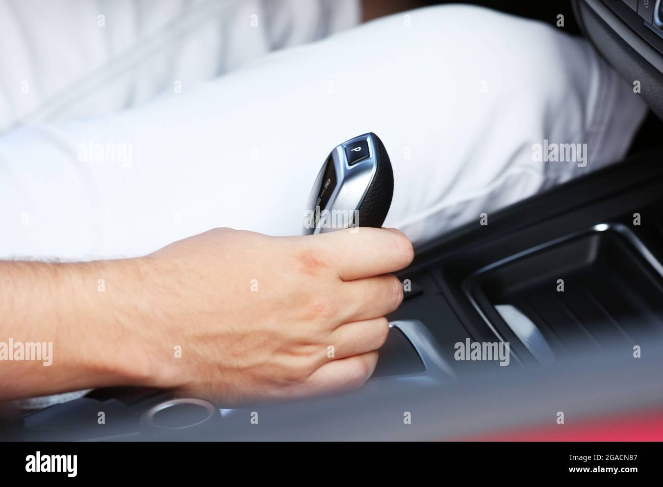Male hand shifting gears in car Stock Photo - Alamy