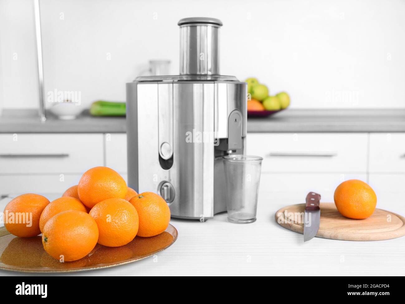 Juicer and fruits on table in kitchen, close up Stock Photo - Alamy