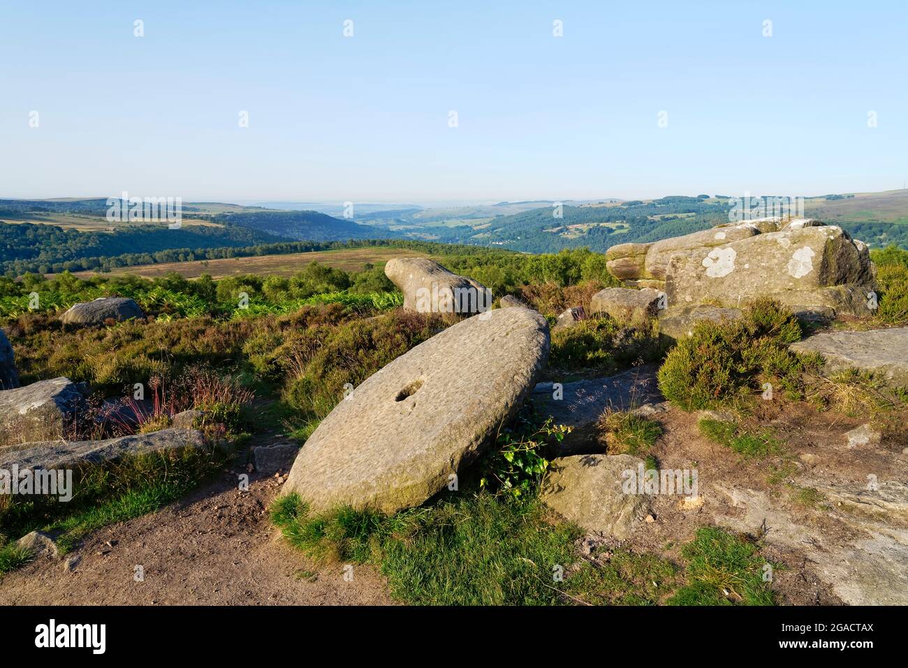 Abandoned, unfinished millstone among weathered gritstone rocks on ...
