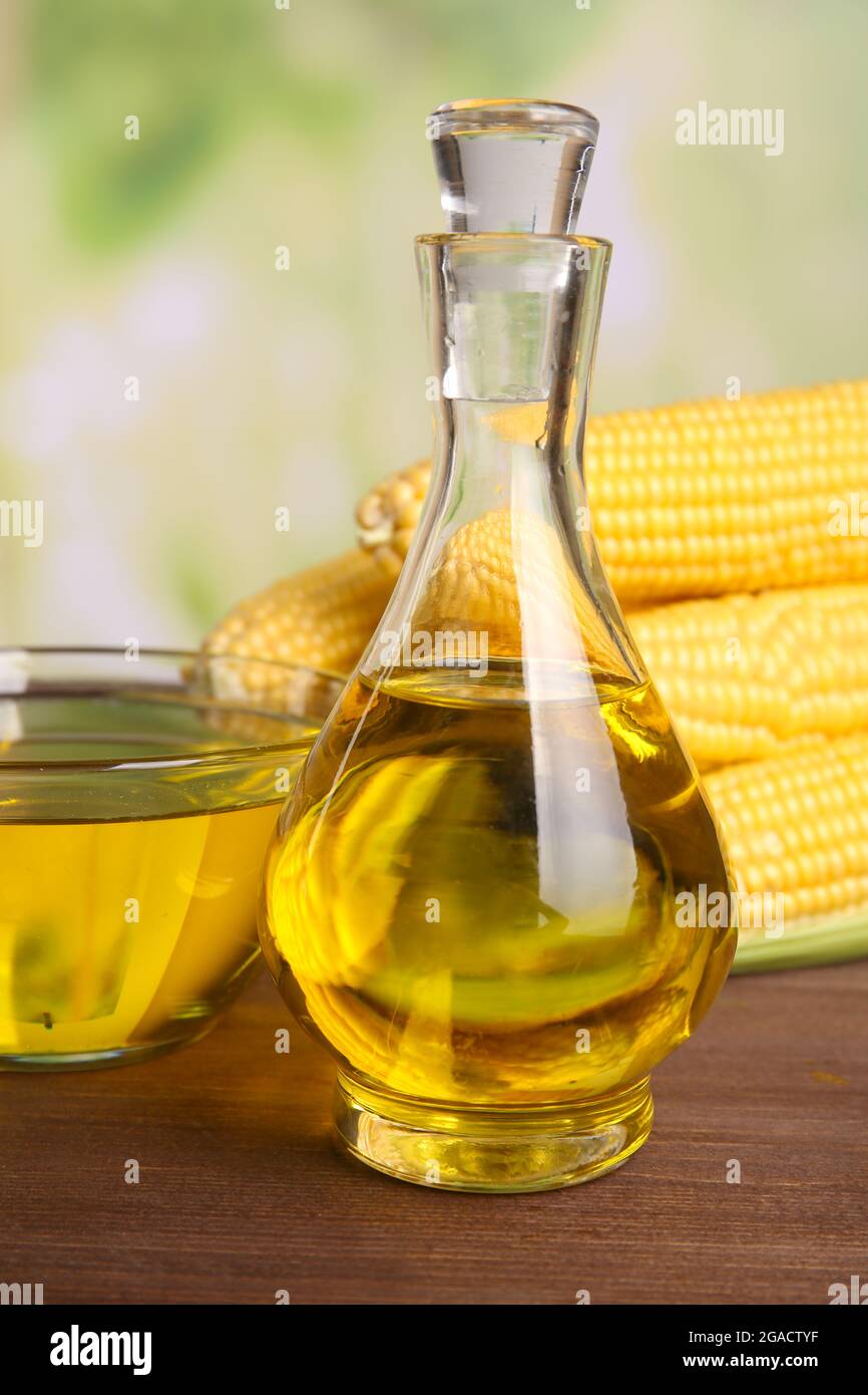 Bottle of oil with fresh corn on bright background Stock Photo - Alamy