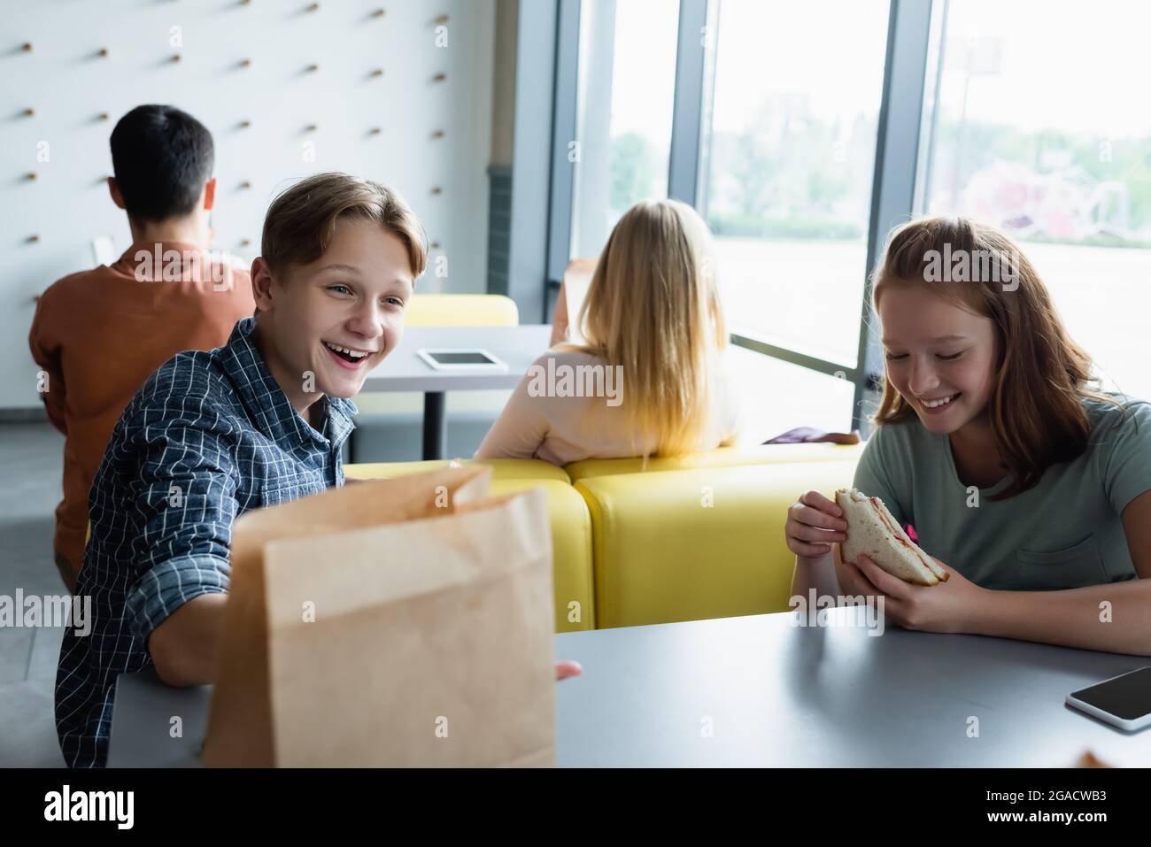 teenage pupils smiling during lunch break in school eatery Stock Photo ...