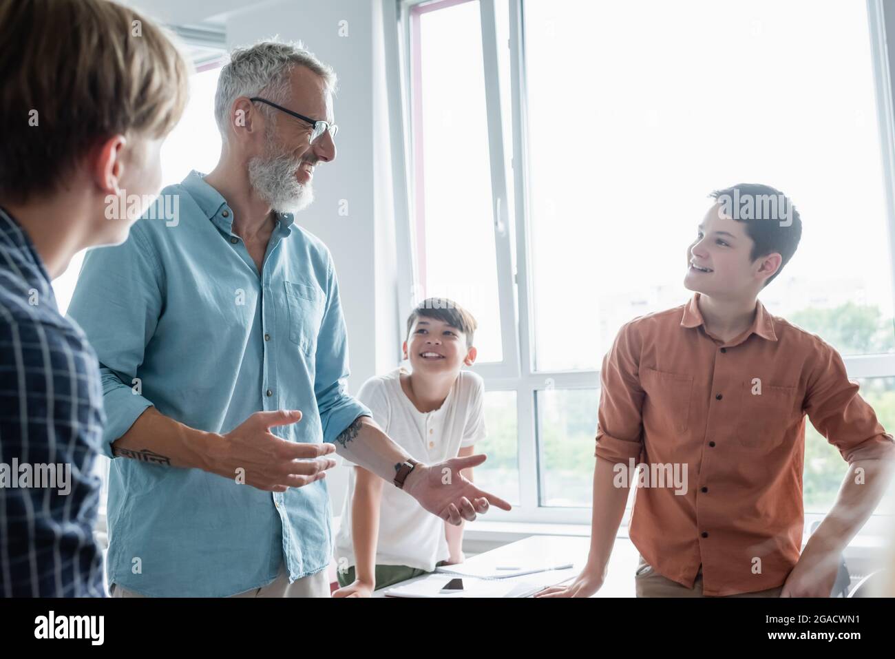 School kids talking in classroom hi-res stock photography and images ...