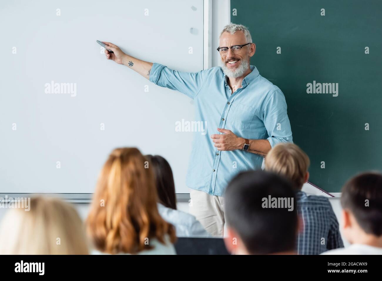 Teacher pointing board classroom hi-res stock photography and images ...