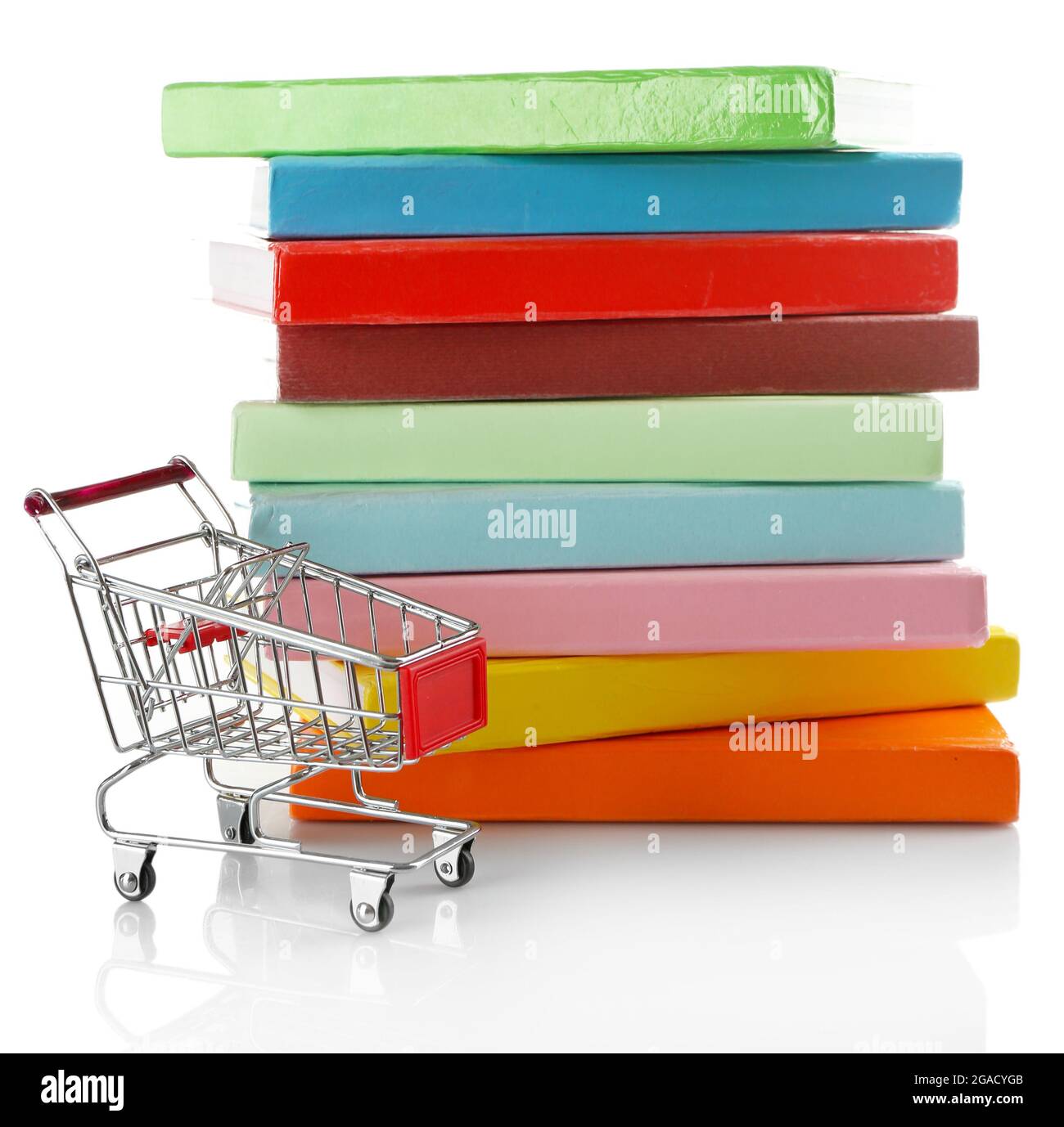 Stack of colorful books with small shopping cart isolated on white ...