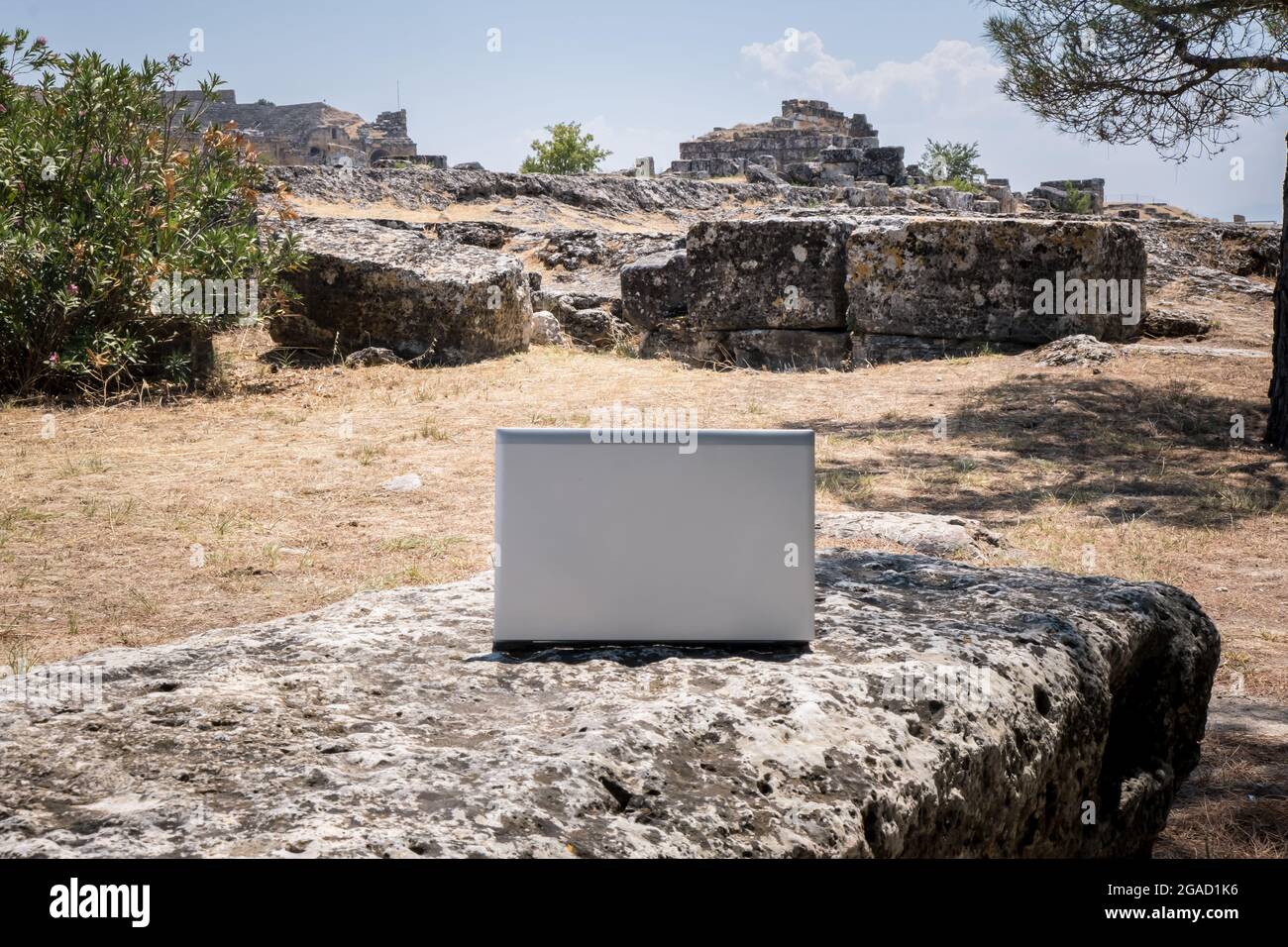 Laptop on the ruins of the ancient city. Working remotely during the ...
