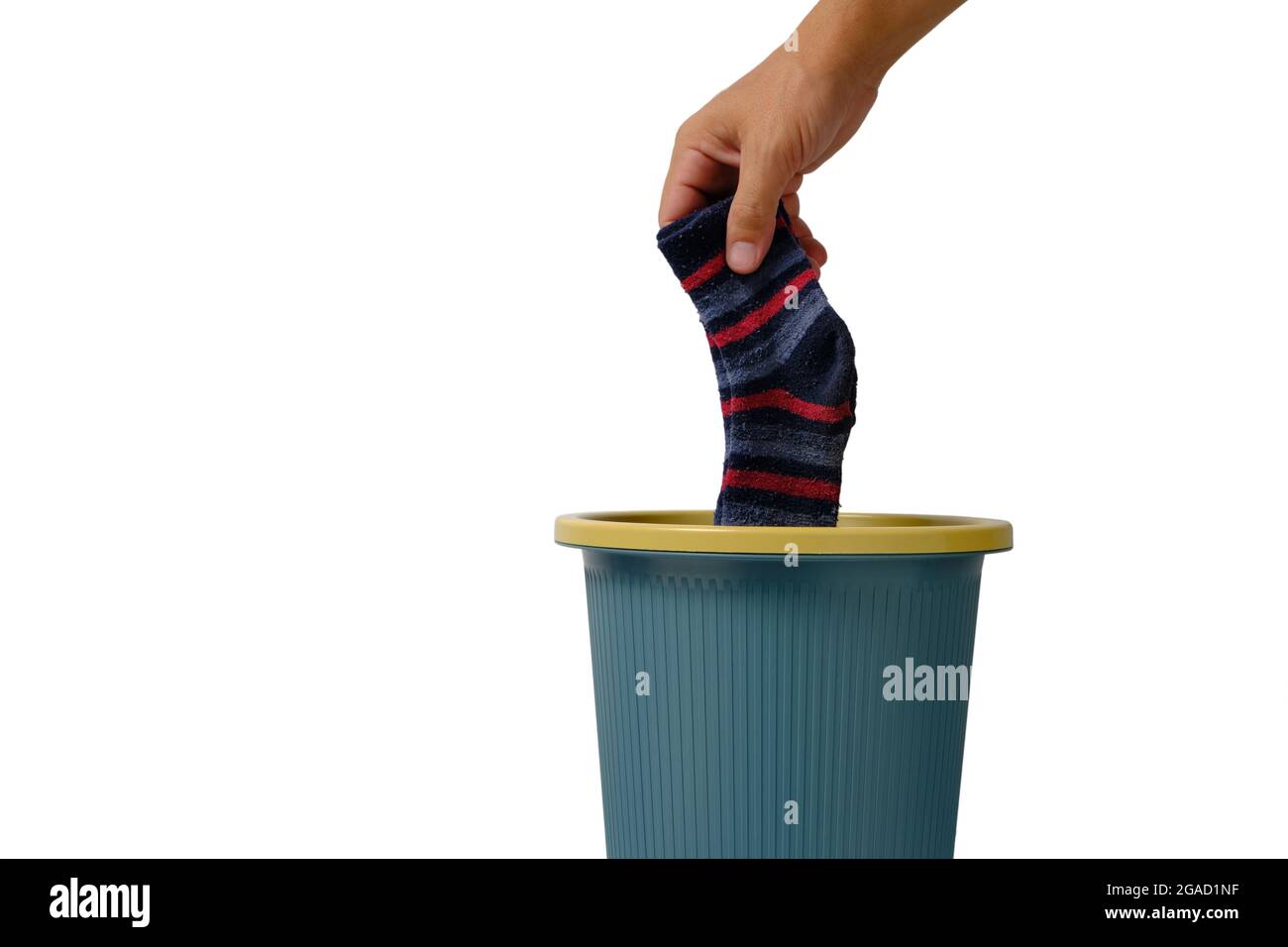 Man hand throws an old sock into trash on white background of isolate ...