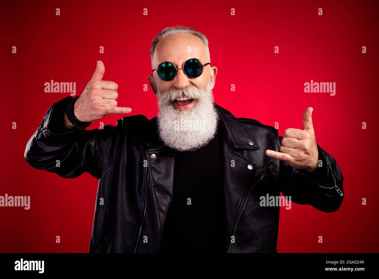 Portrait of attractive cheerful grey-haired man having fun showing call ...