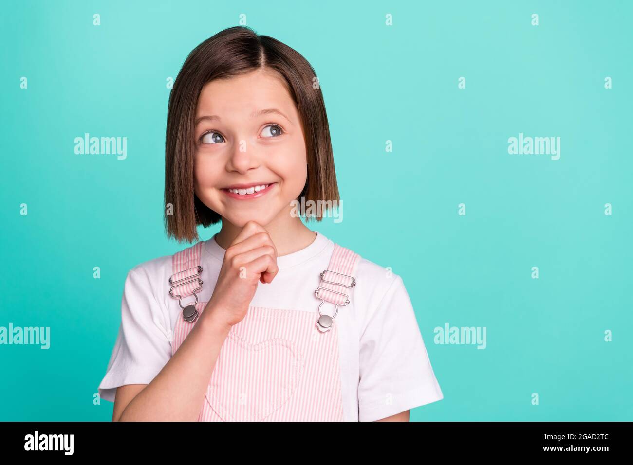 Photo of thoughtful young little girl look empty space ideal dream hand ...