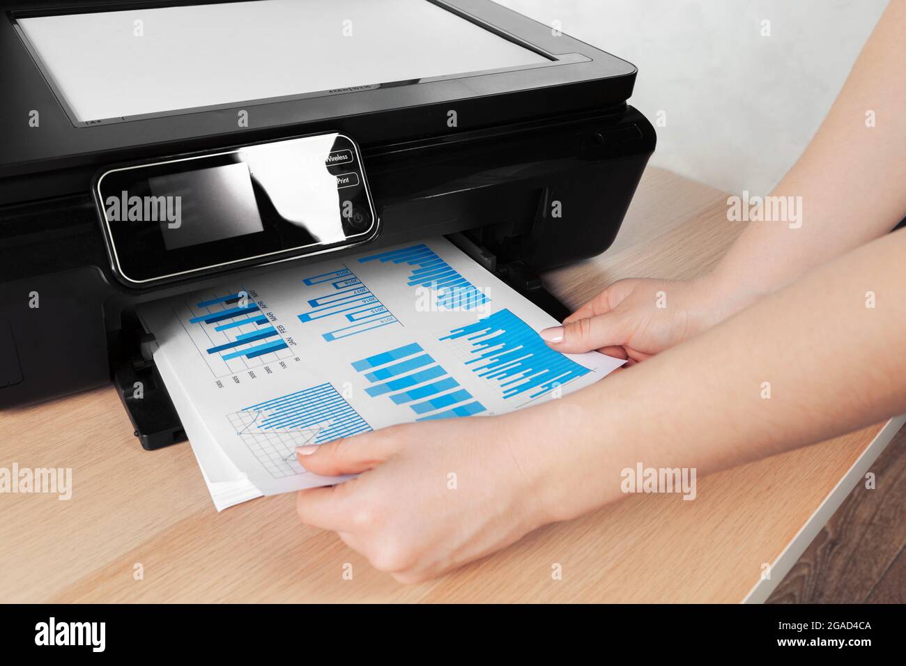 Unrecognizable young businesswoman making copies on the photocopy ...