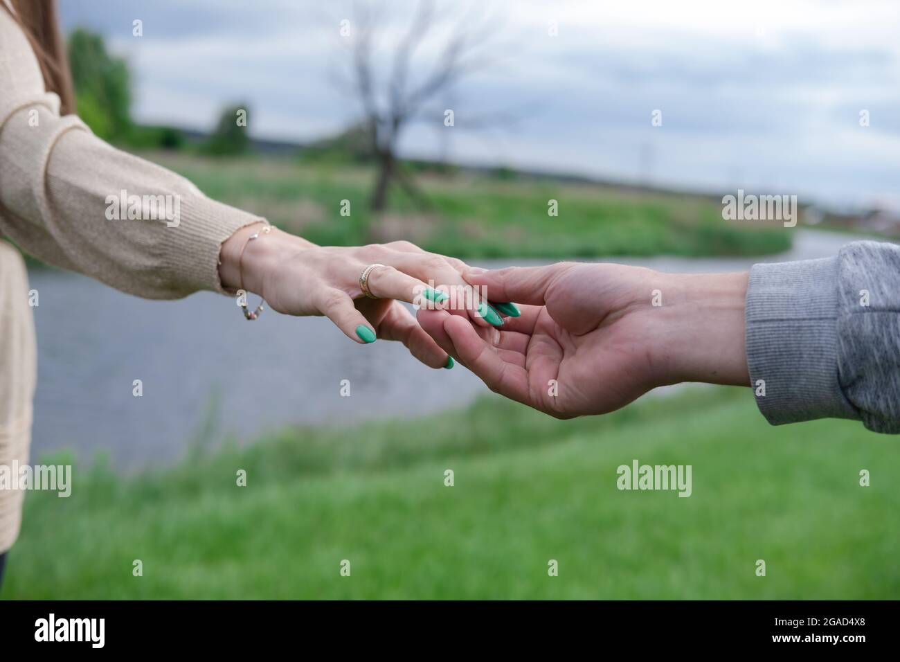 Hands of man and woman reaching to each other. Soft, gentle touch of ...