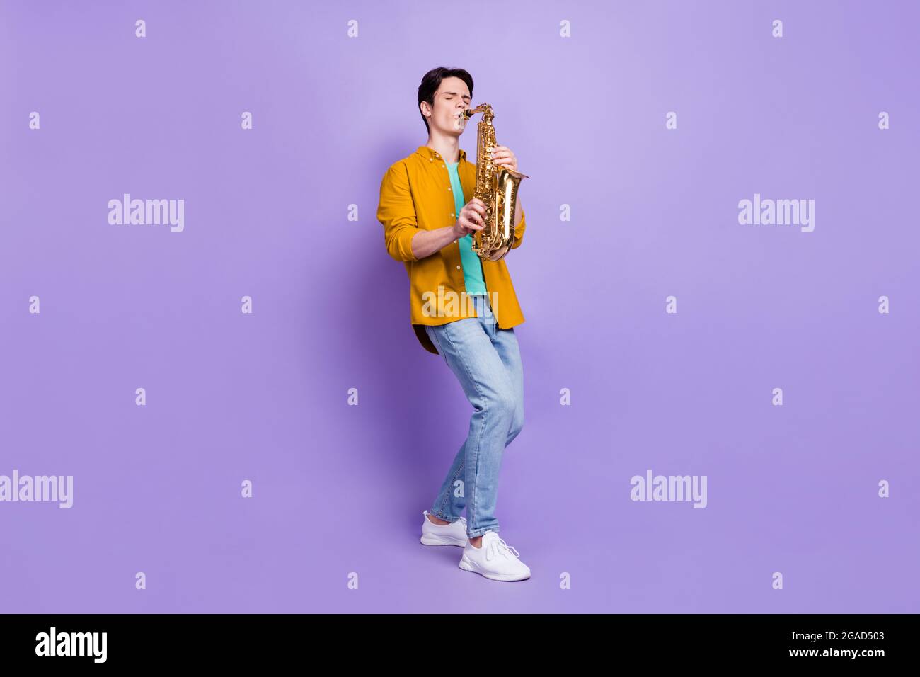 Full body photo of cool brunet young guy play sax wear brown shirt ...