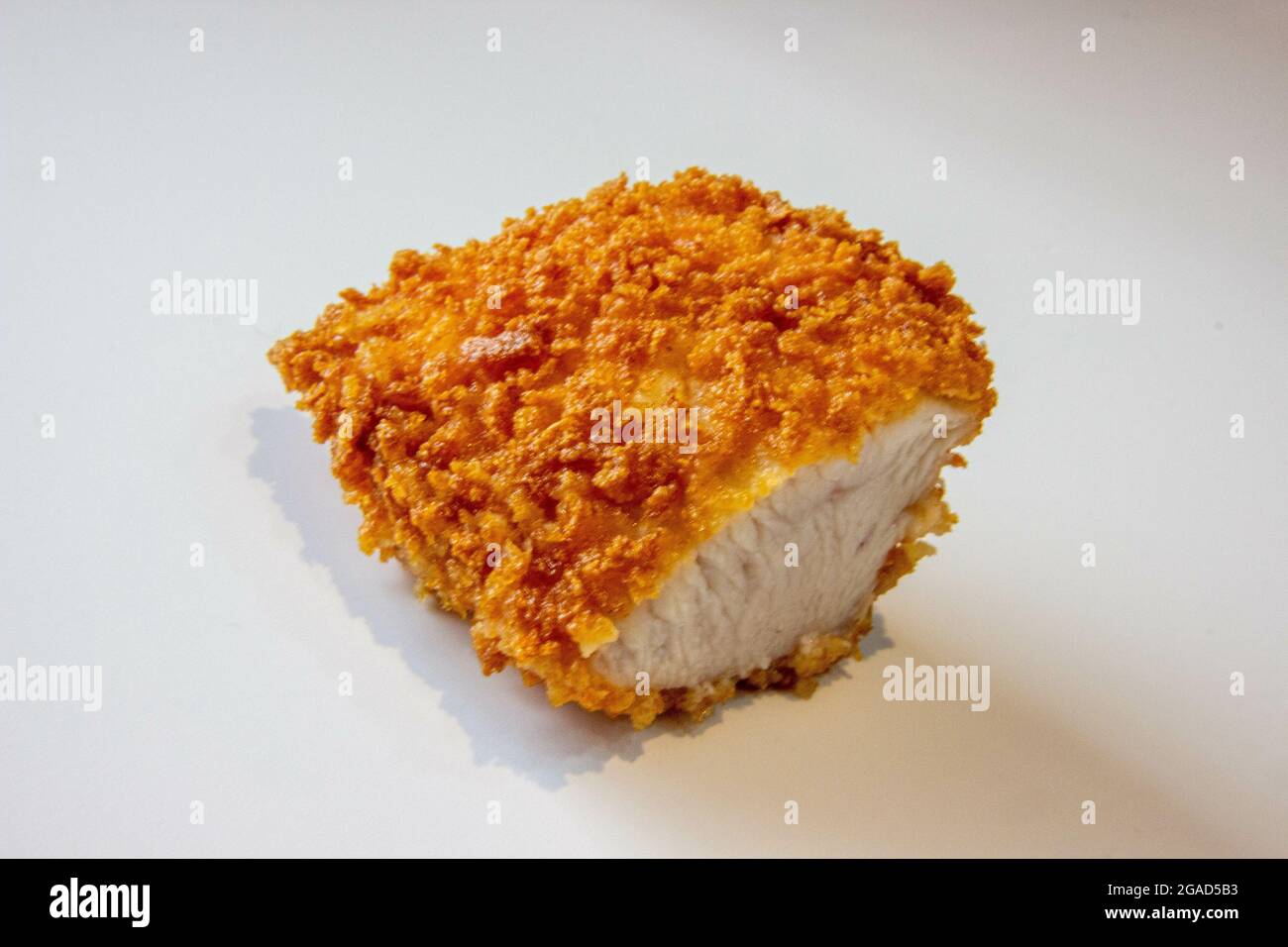 Closeup shot of a crispy chicken strip isolated on a white background ...