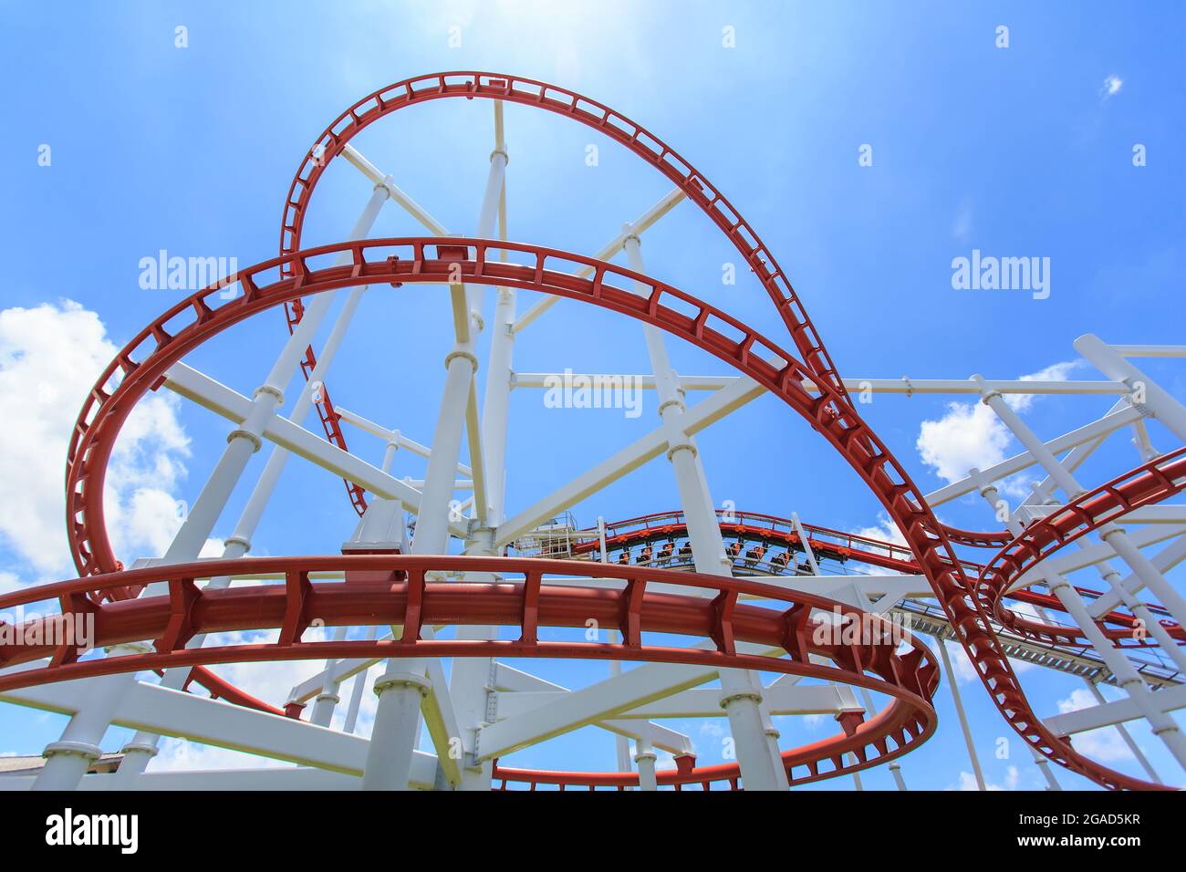 Red roller coaster rail in bright blue sky Stock Photo - Alamy