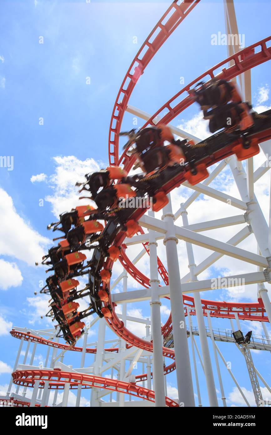 People playing roller coaster in blue sky Stock Photo - Alamy