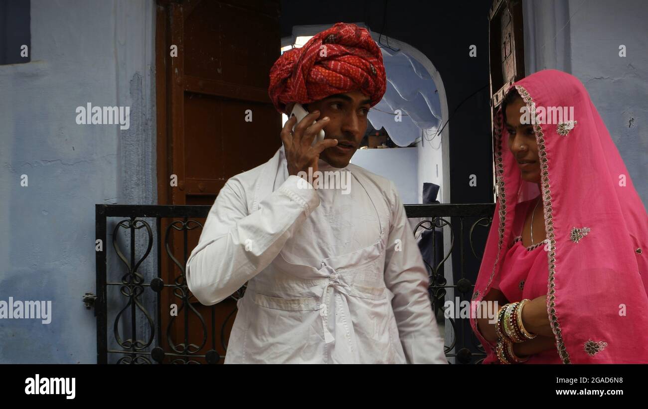 Closeup of an Indian couple in traditional outfits. The man talking on ...