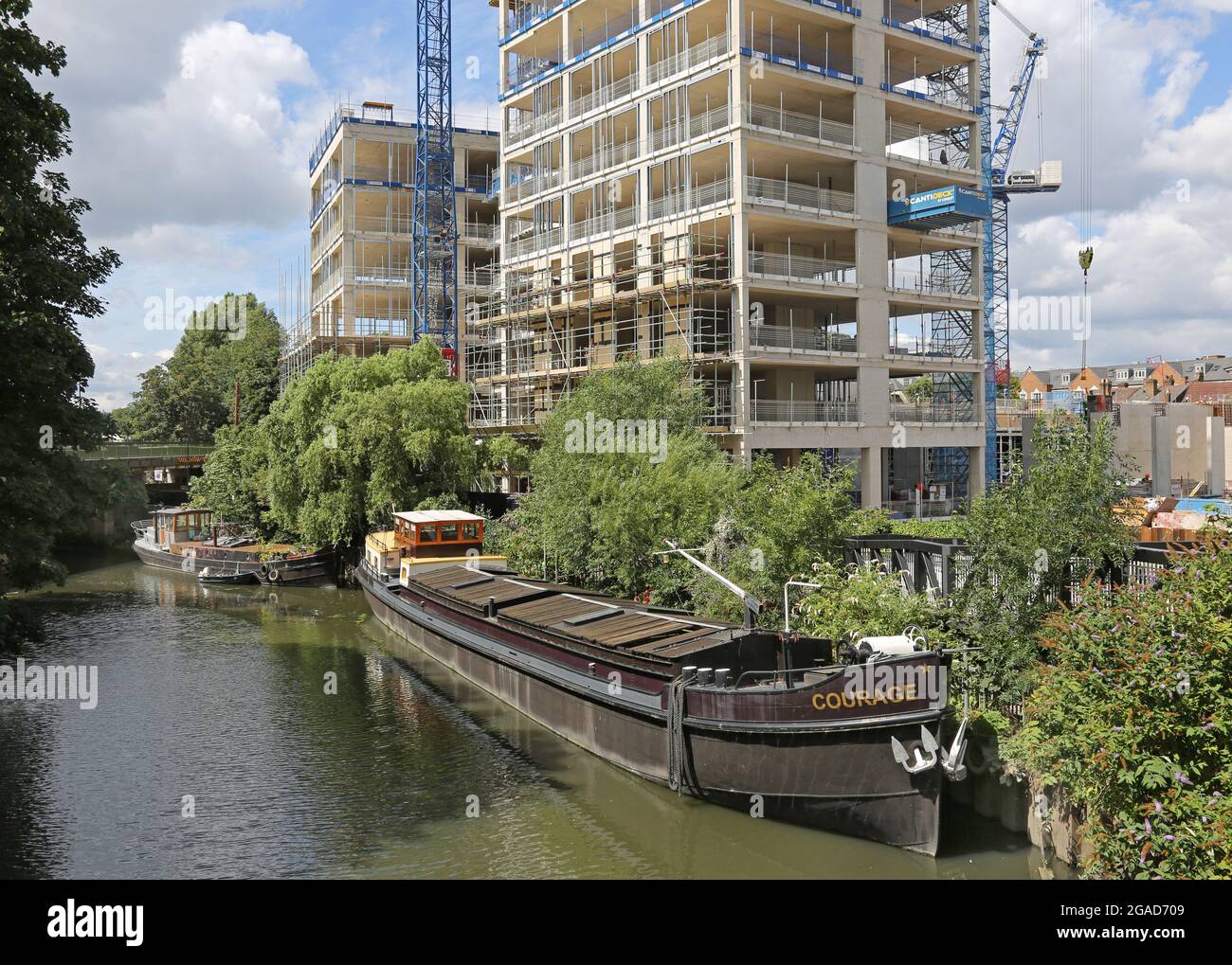 Construction of new apartment blocks next to the River Brent, London ...