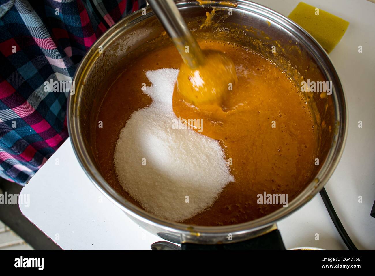 The process of producing apricot jam at home. The pulp of apricots is ...