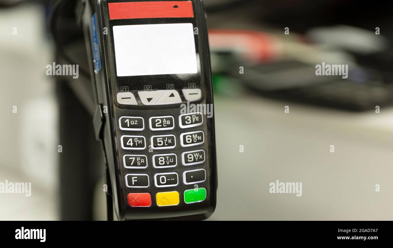 Pay pass payment terminal by card or smartphone close-up in a store or ...